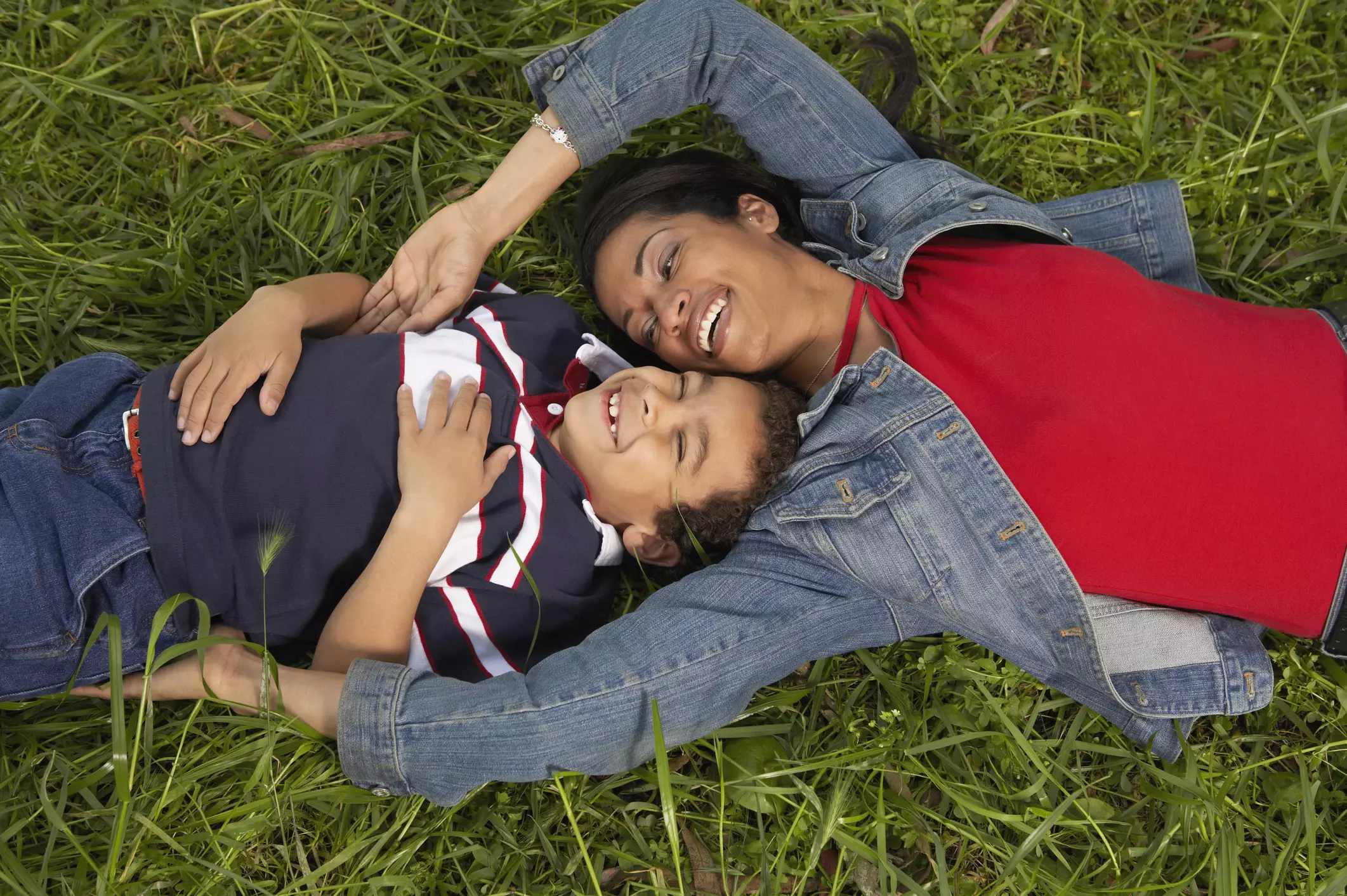 Mutter und ihr ADHS-Sohn liegen auf dem Gras