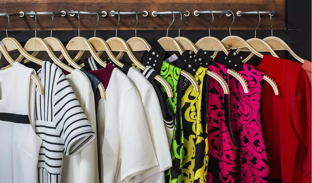Verschiedene Blusen auf Kleiderbügeln im Schrank, die einer ADHS-Frau gehören