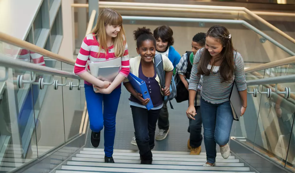 sekelompok gadis sekolah menengah dengan ADHD berjalan menaiki tangga, berbicara